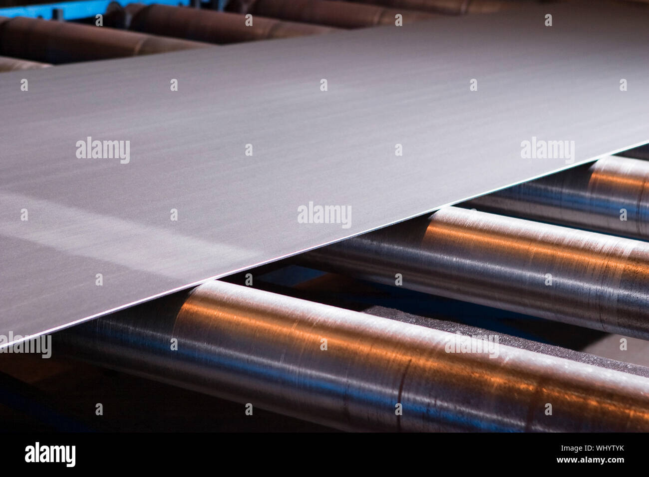 Continuous sheet of metallic material being fed through machine Stock ...