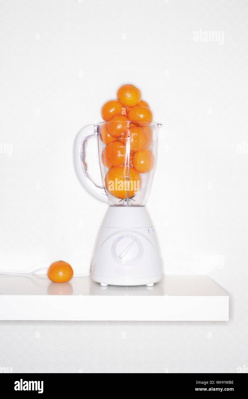 Orange fruits in blender Stock Photo - Alamy