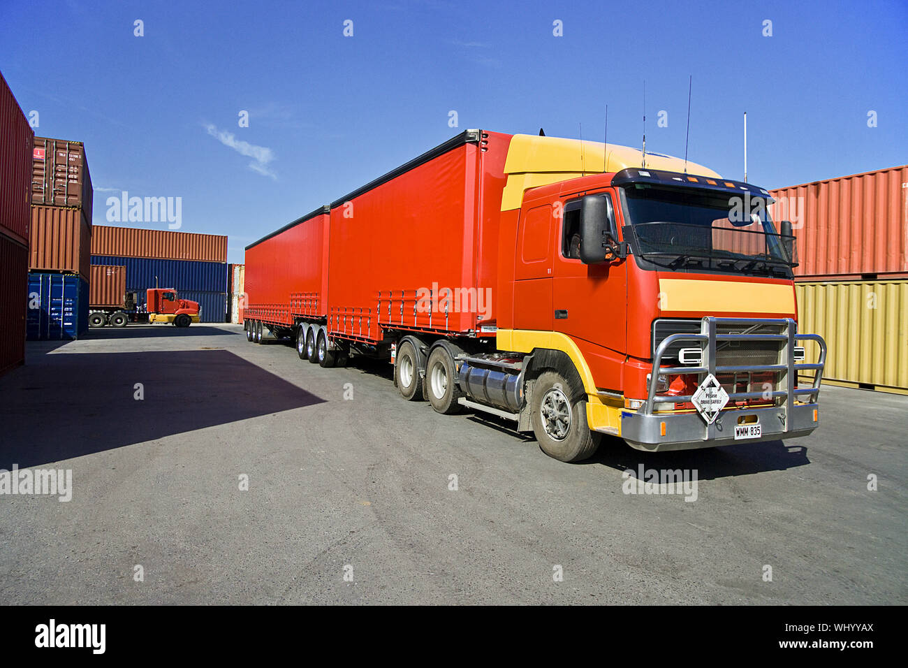 Truck and cargo containers at port Stock Photo - Alamy