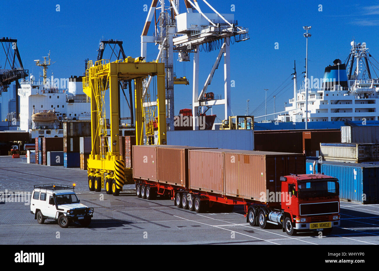 Machines in cargo container port Stock Photo - Alamy