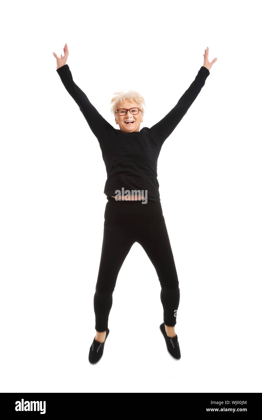 Happy old woman jumping. Isolated on white Stock Photo - Alamy