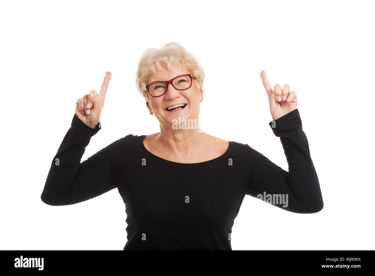 An old happy lady pointing on a copy space. isolated on white Stock ...