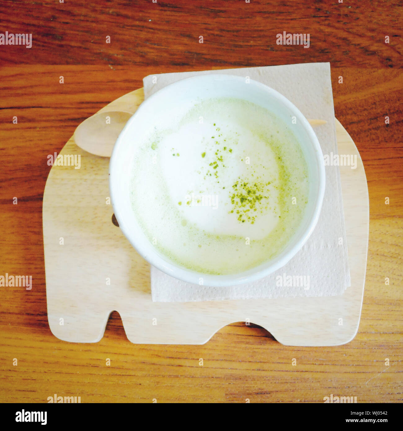 Matcha green tea latte on wooden tray with retro filter effect Stock ...