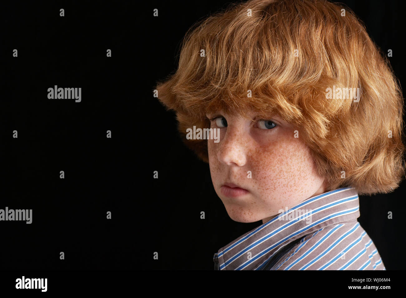 Closeup portrait of angry young boy over black background Stock Photo ...