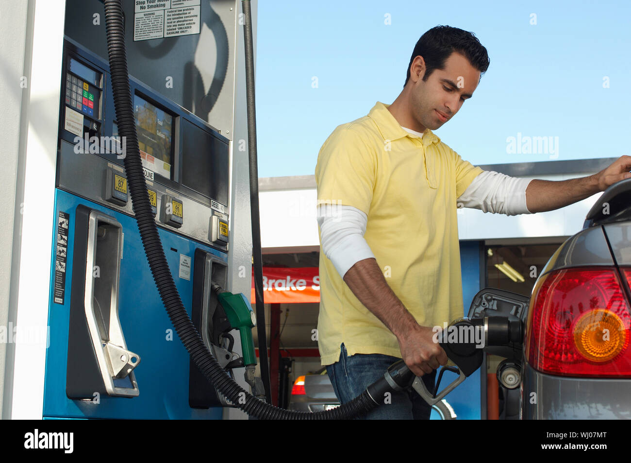 Man pumping gas Stock Photo - Alamy