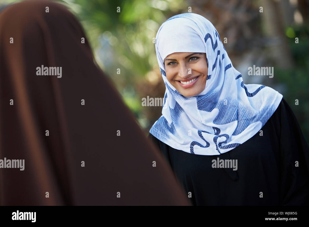 Two muslim woman talking Stock Photo - Alamy