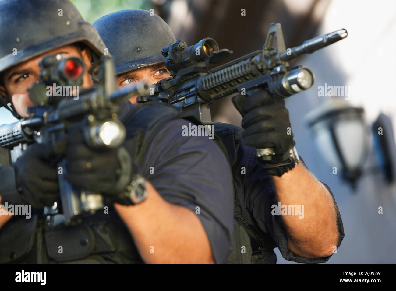 Closeup of police officers aiming with guns Stock Photo - Alamy