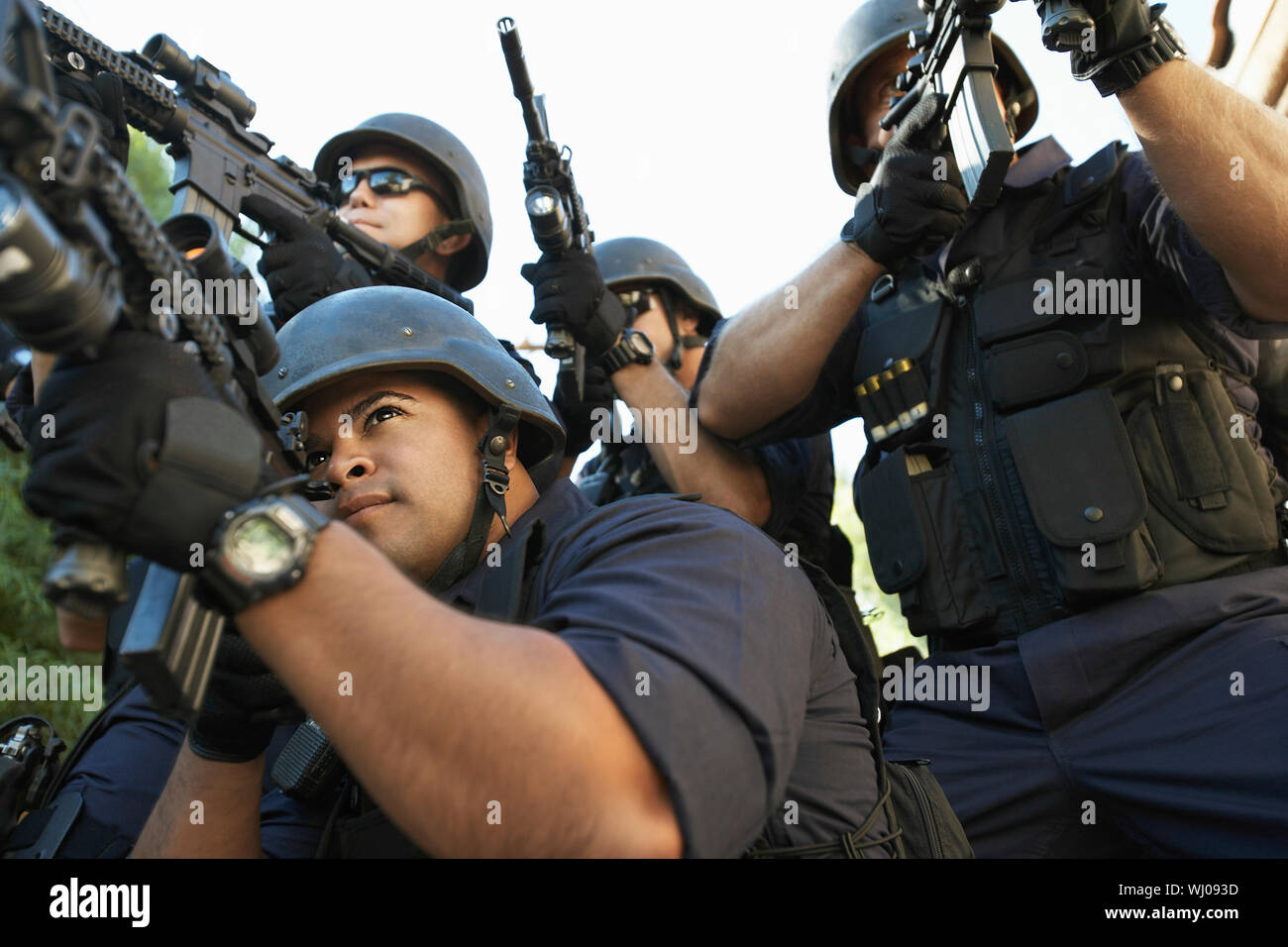 Group of police officers aiming with guns Stock Photo - Alamy