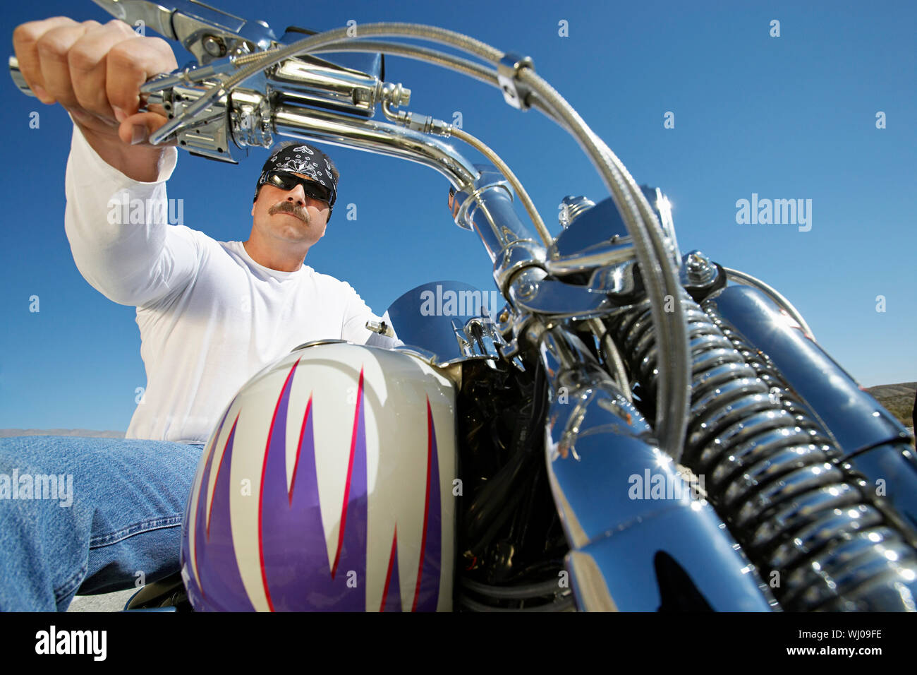 Biker riding motorcycle, low angle view Stock Photo - Alamy