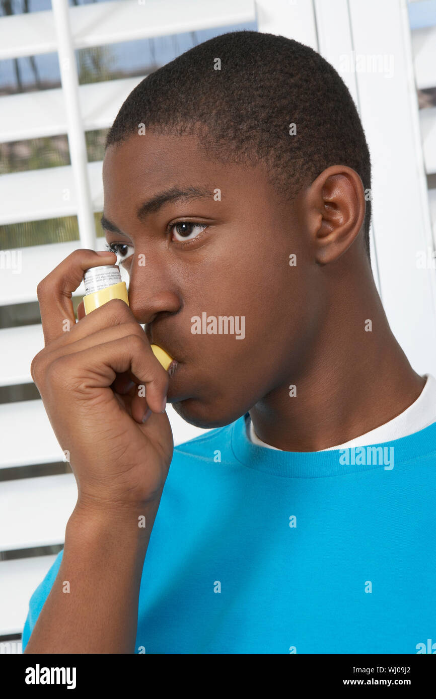 Young man using asthma inhaler Stock Photo - Alamy