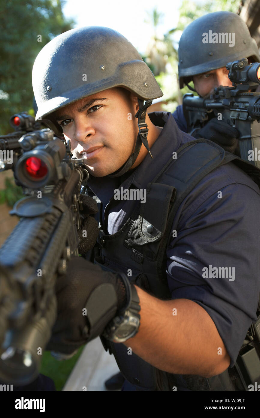Police officers aiming with guns Stock Photo - Alamy