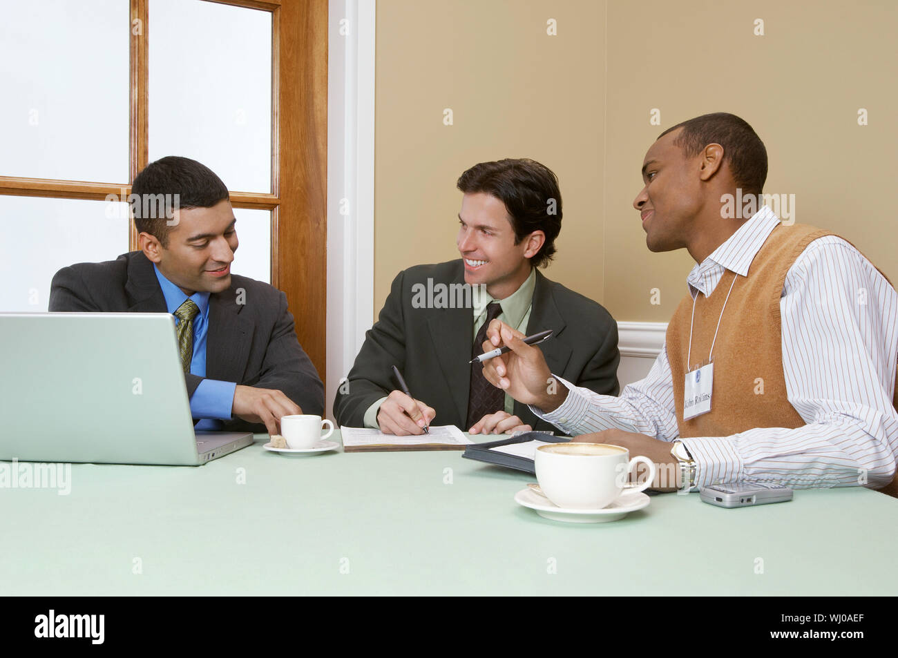 Three business men talking Stock Photo - Alamy