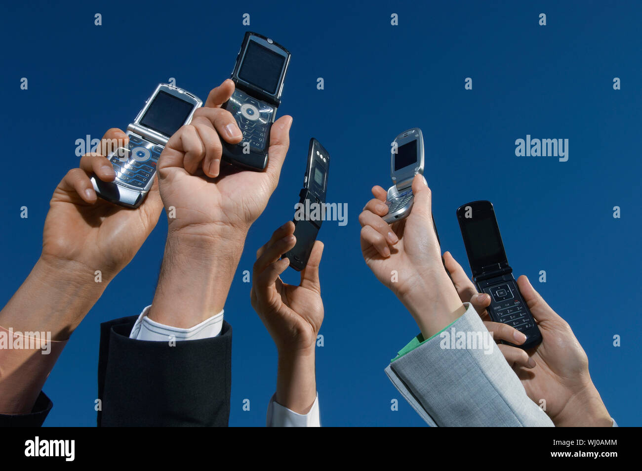 Group of hands holding cell phones hi-res stock photography and images ...