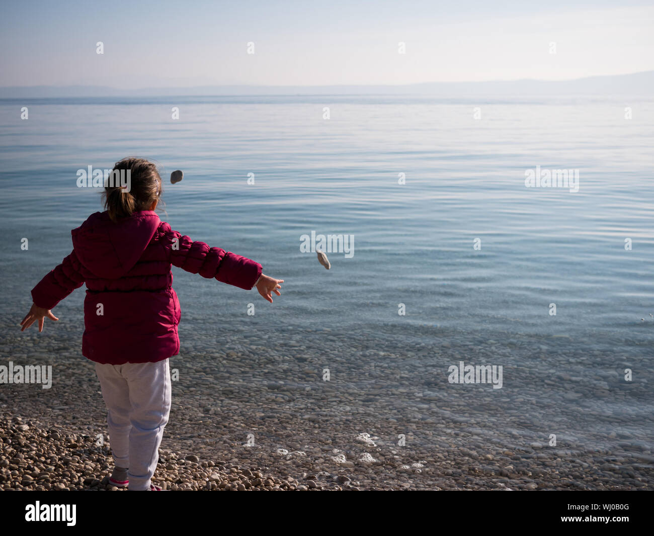 Girl throwing stones hi-res stock photography and images - Alamy