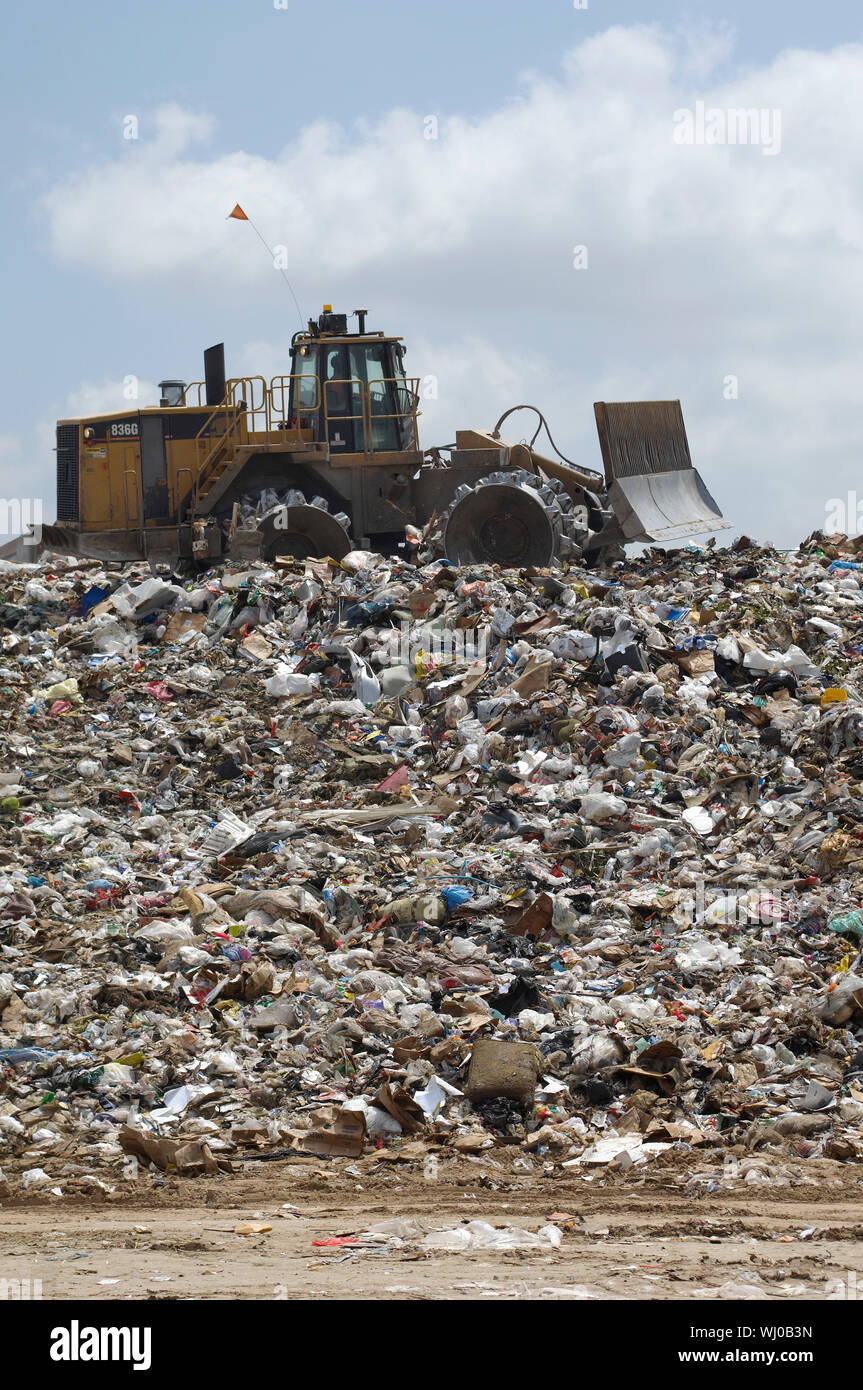 Digger working at landfill site Stock Photo - Alamy