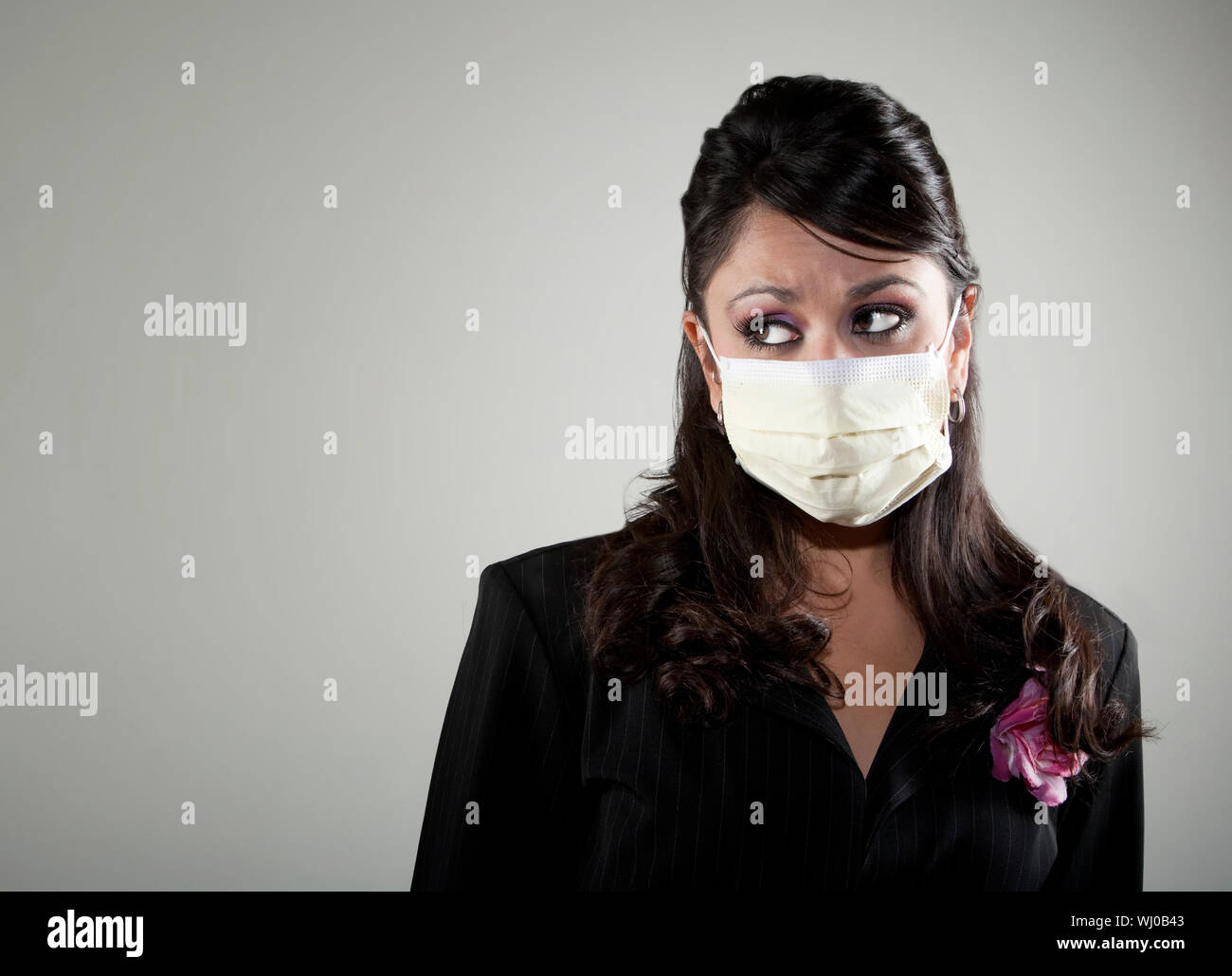 Pretty young woman wearing a breathing mask for protection from germs ...