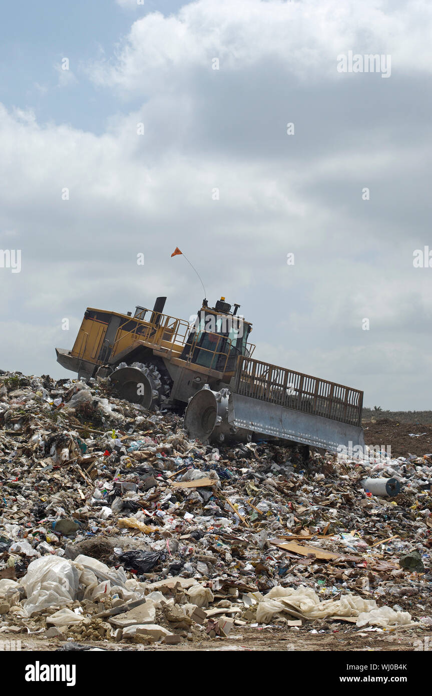 Digger working at landfill site Stock Photo - Alamy