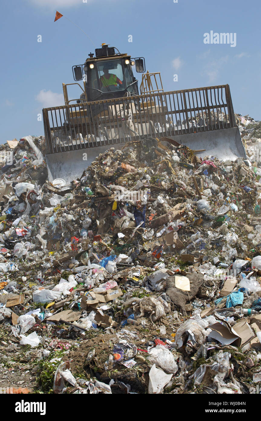 Digger working at landfill site Stock Photo - Alamy