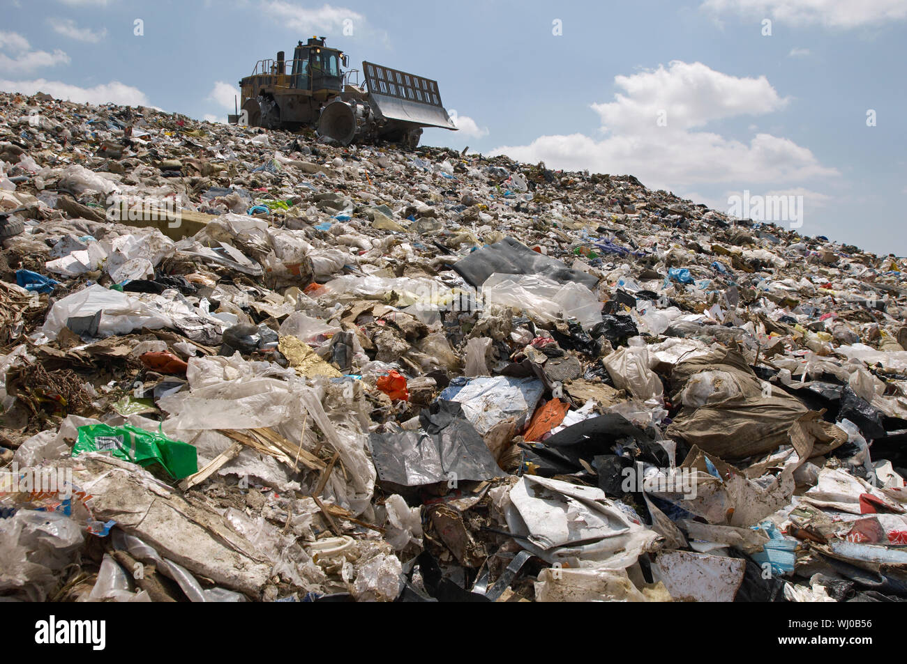 Digger working at landfill site Stock Photo - Alamy