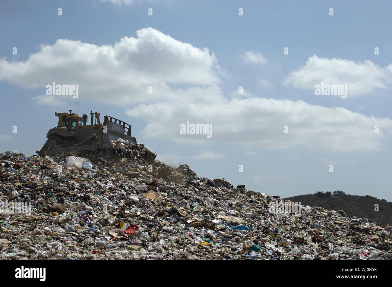 Digger working at landfill site Stock Photo - Alamy