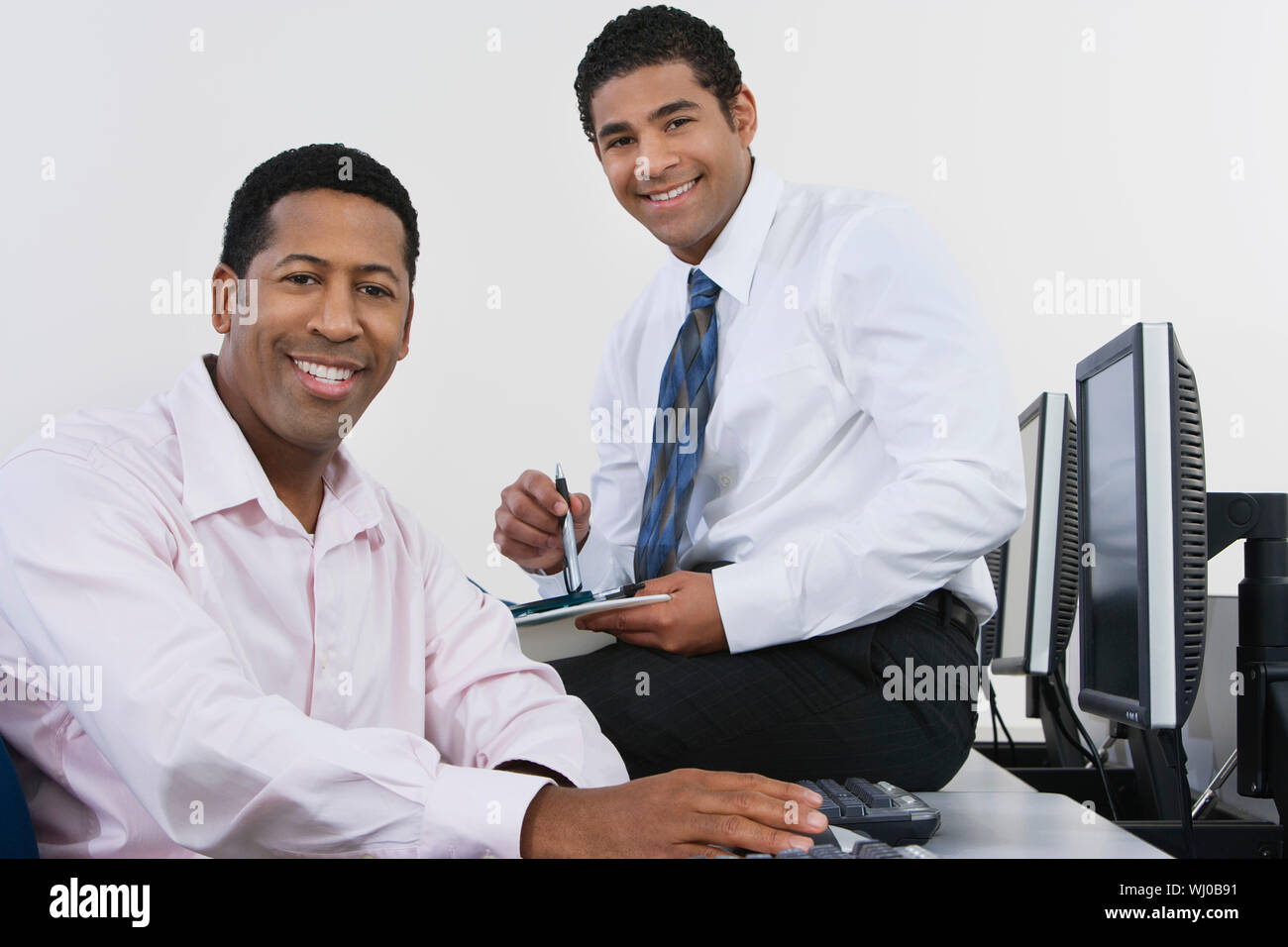 Portrait of two business men in office Stock Photo - Alamy