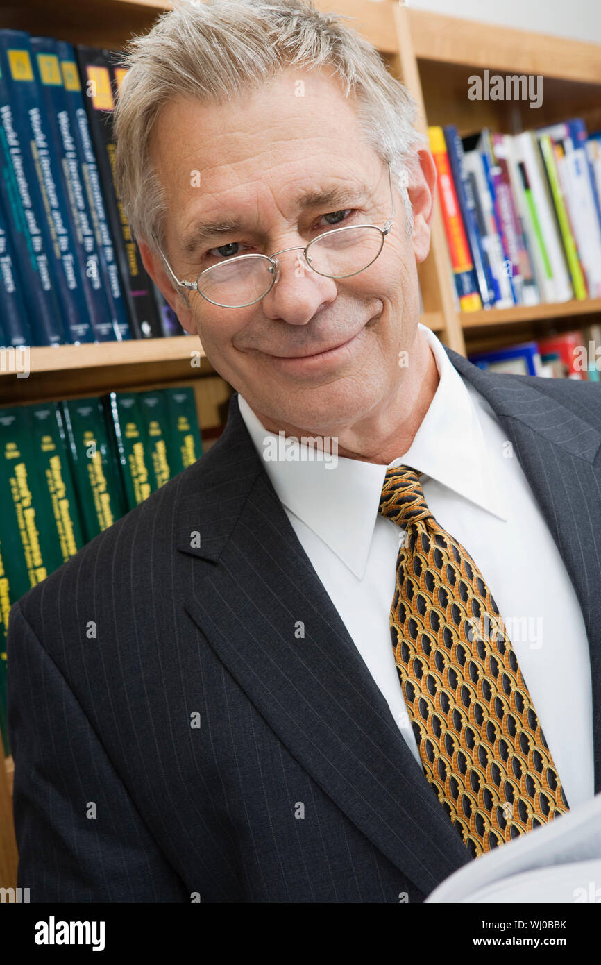 portrait of senior man wearing suit in library Stock Photo - Alamy