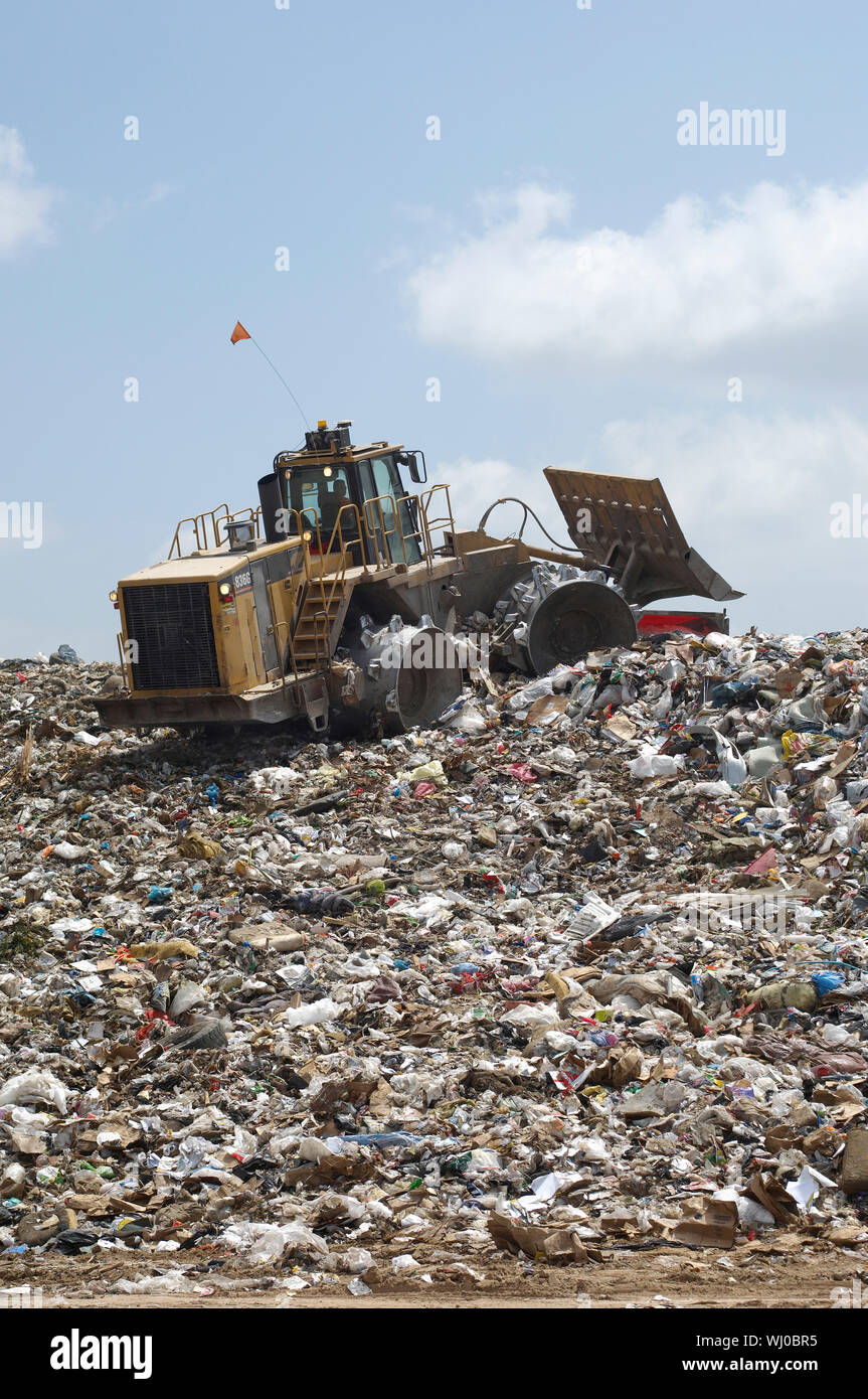 Digger working at landfill site Stock Photo - Alamy