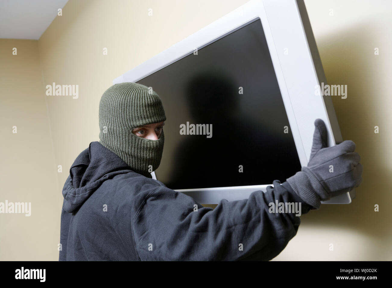 Thief stealing flat screen television Stock Photo - Alamy