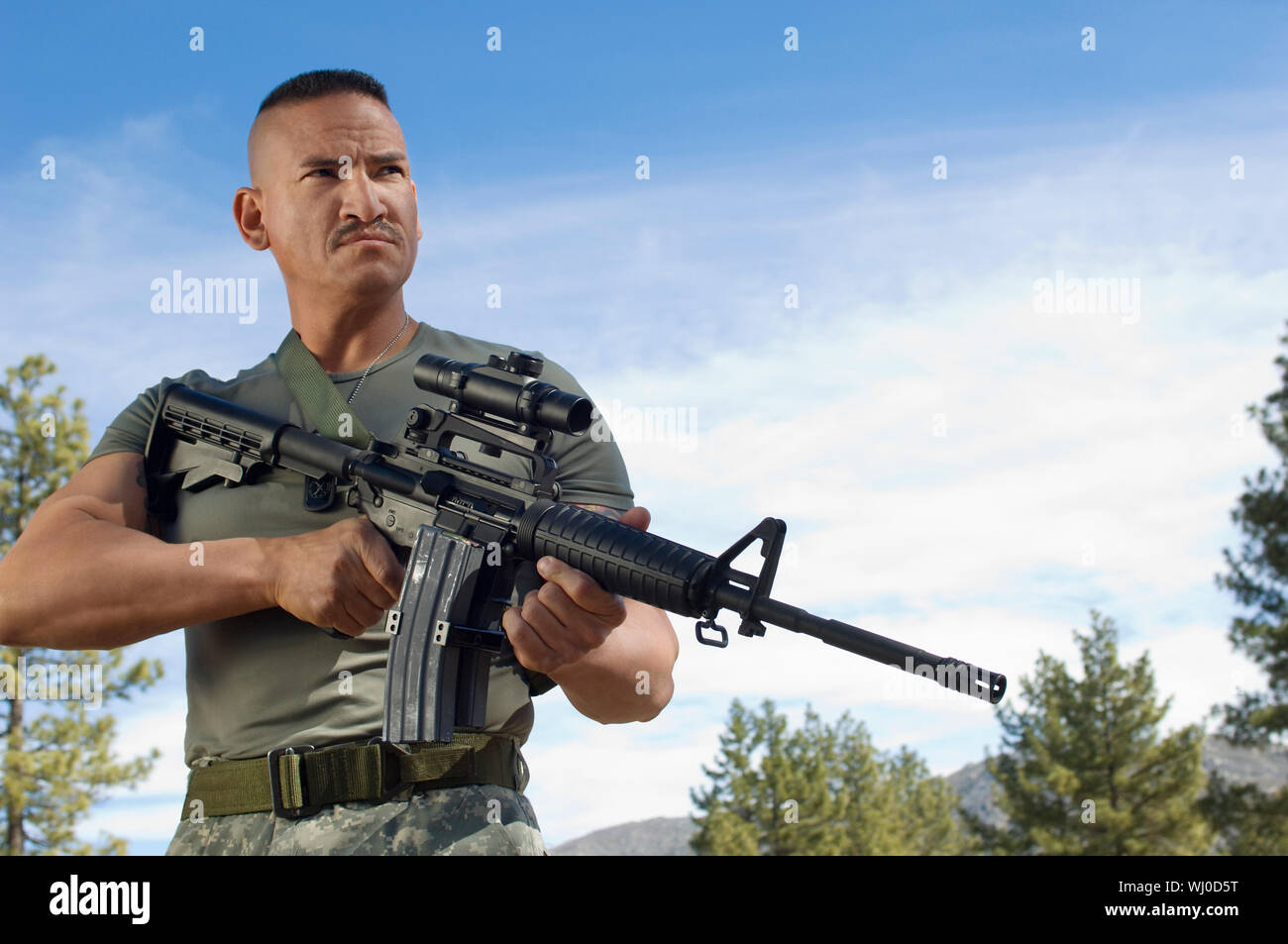 Portrait of soldier with machine gun Stock Photo - Alamy