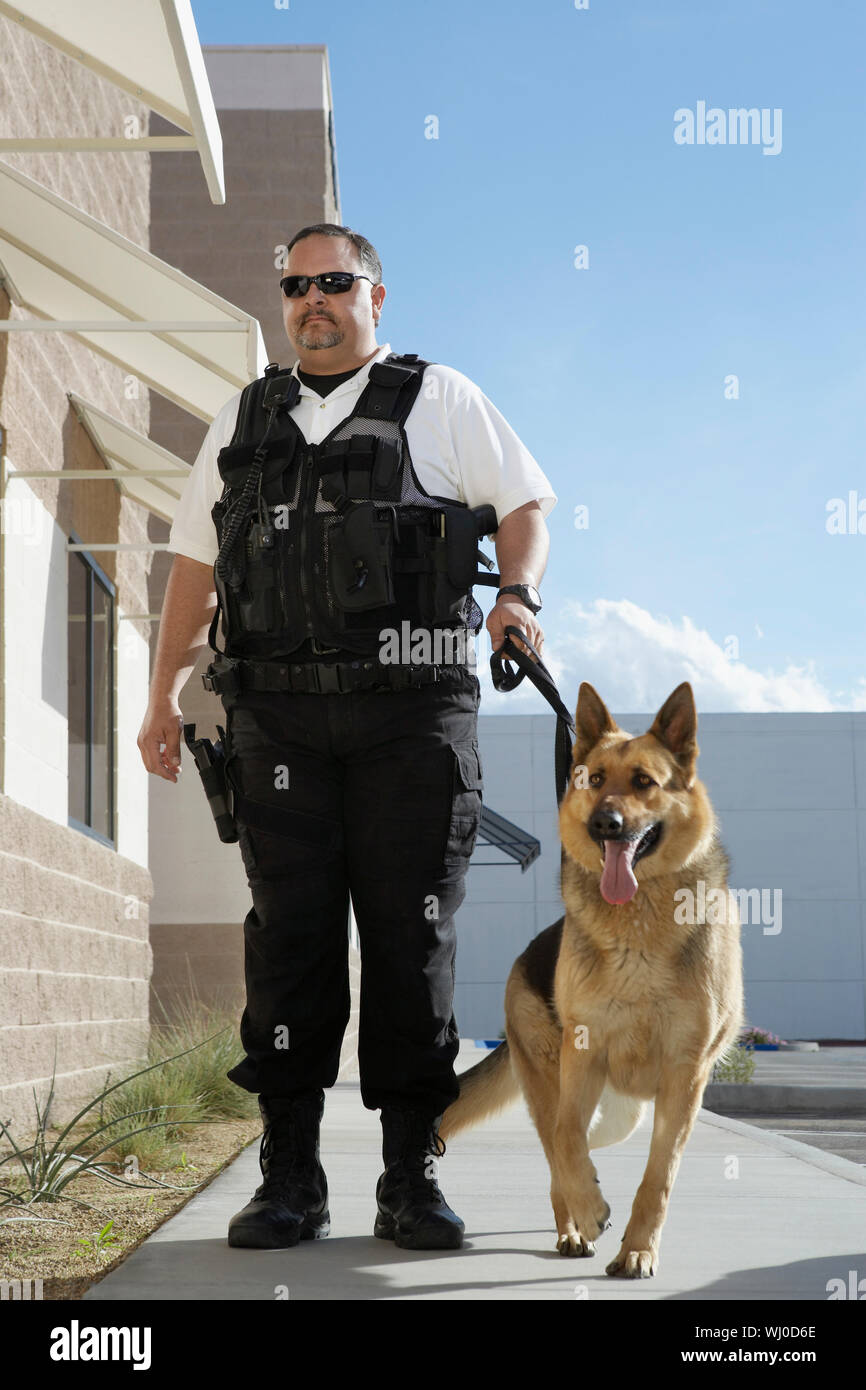 Security guard with dog on patrol Stock Photo - Alamy