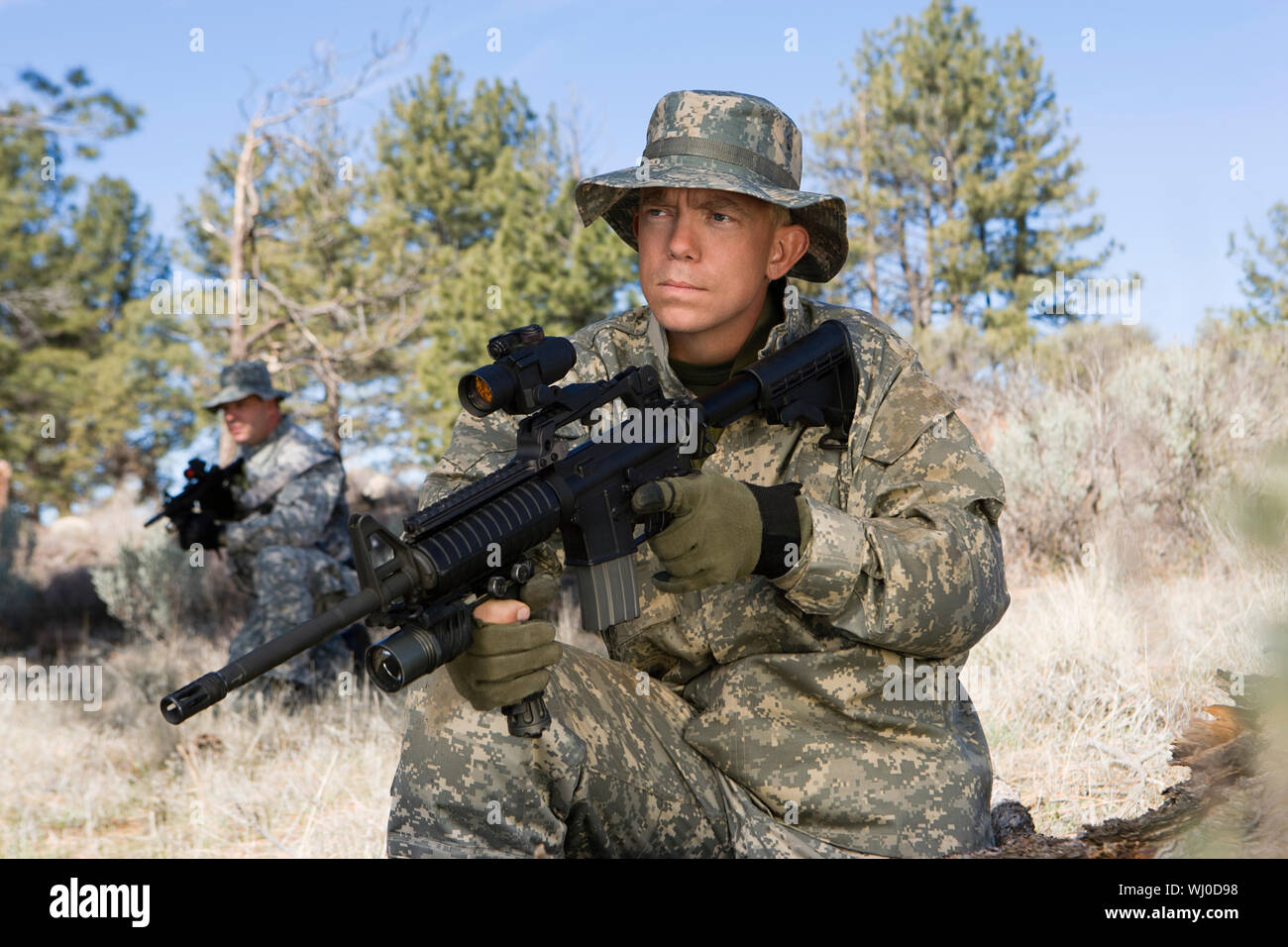 Portrait of soldier with machine gun Stock Photo - Alamy
