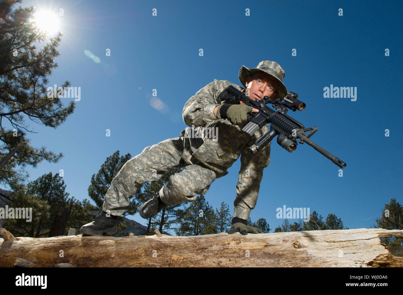 Soldier jumping over log Stock Photo - Alamy