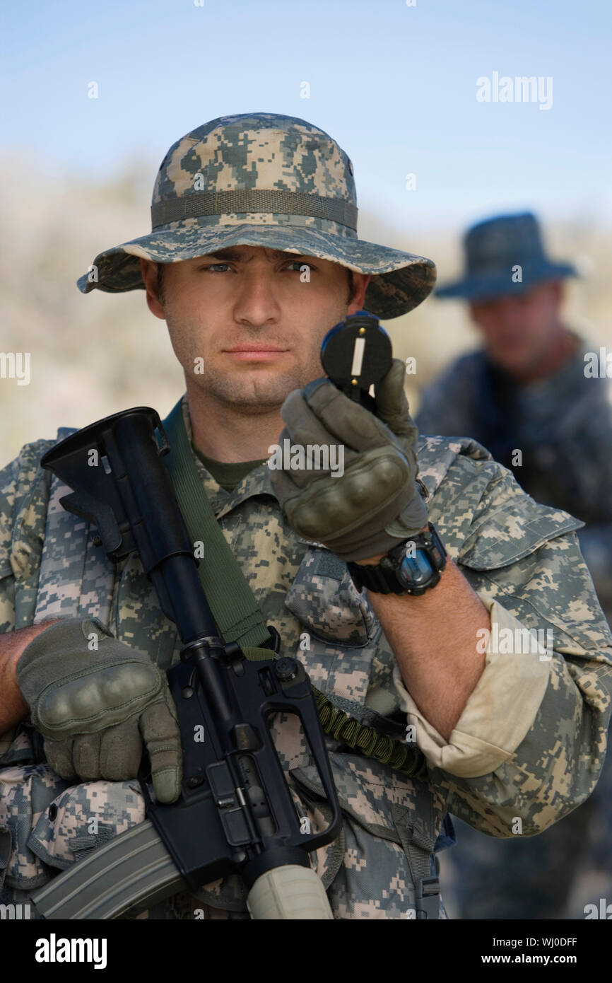 Soldier using compass Stock Photo - Alamy