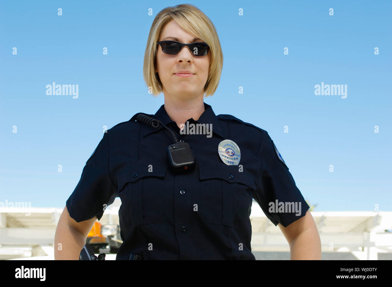 A female police officer standing against clear sky Stock Photo - Alamy