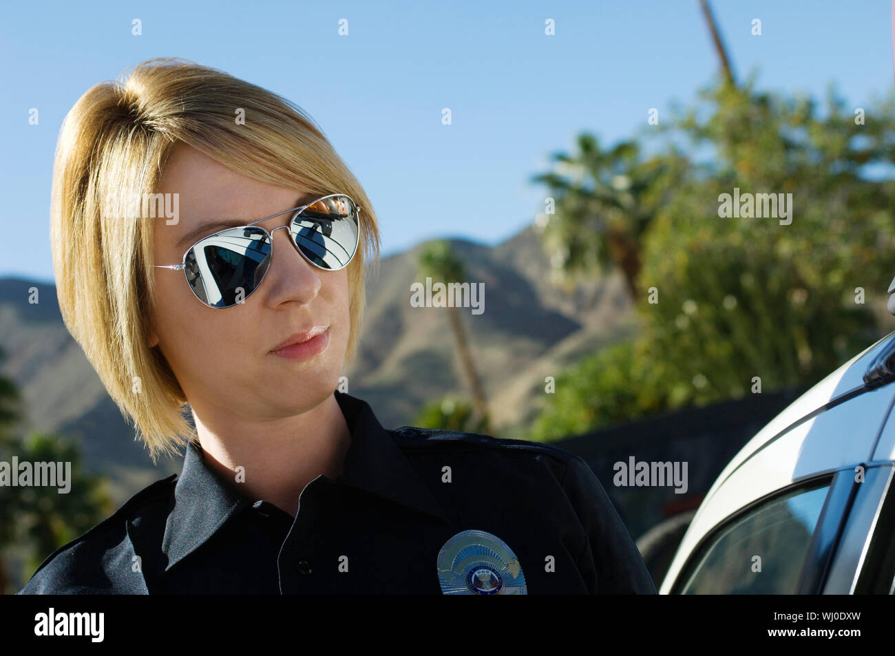 A middle aged female police officer looking away Stock Photo - Alamy