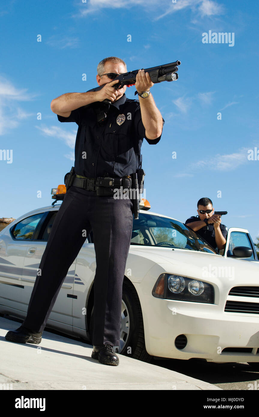 Police Officer Aiming Shotgun Stock Photo - Alamy