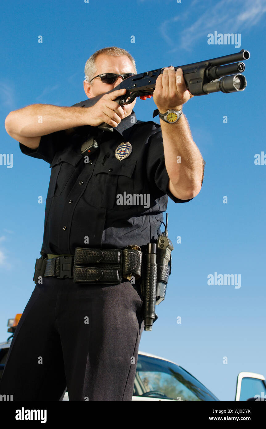 Police Officer Aiming Shotgun Stock Photo - Alamy