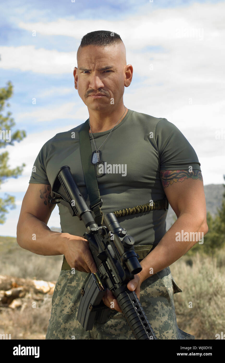 Portrait of soldier with machine gun Stock Photo - Alamy