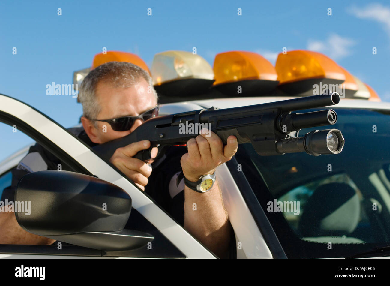 Police Officer Aiming Shotgun Stock Photo - Alamy
