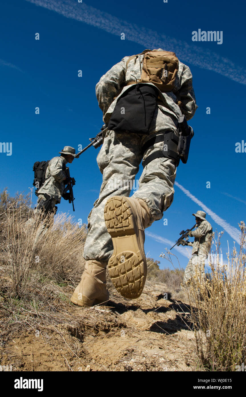 Soldiers walking in field Stock Photo - Alamy