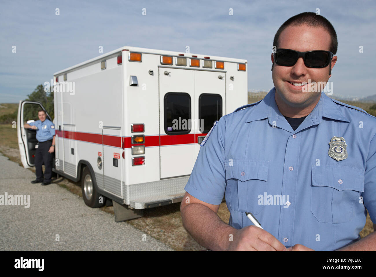 Portrait of paramedic in front of ambulance Stock Photo - Alamy