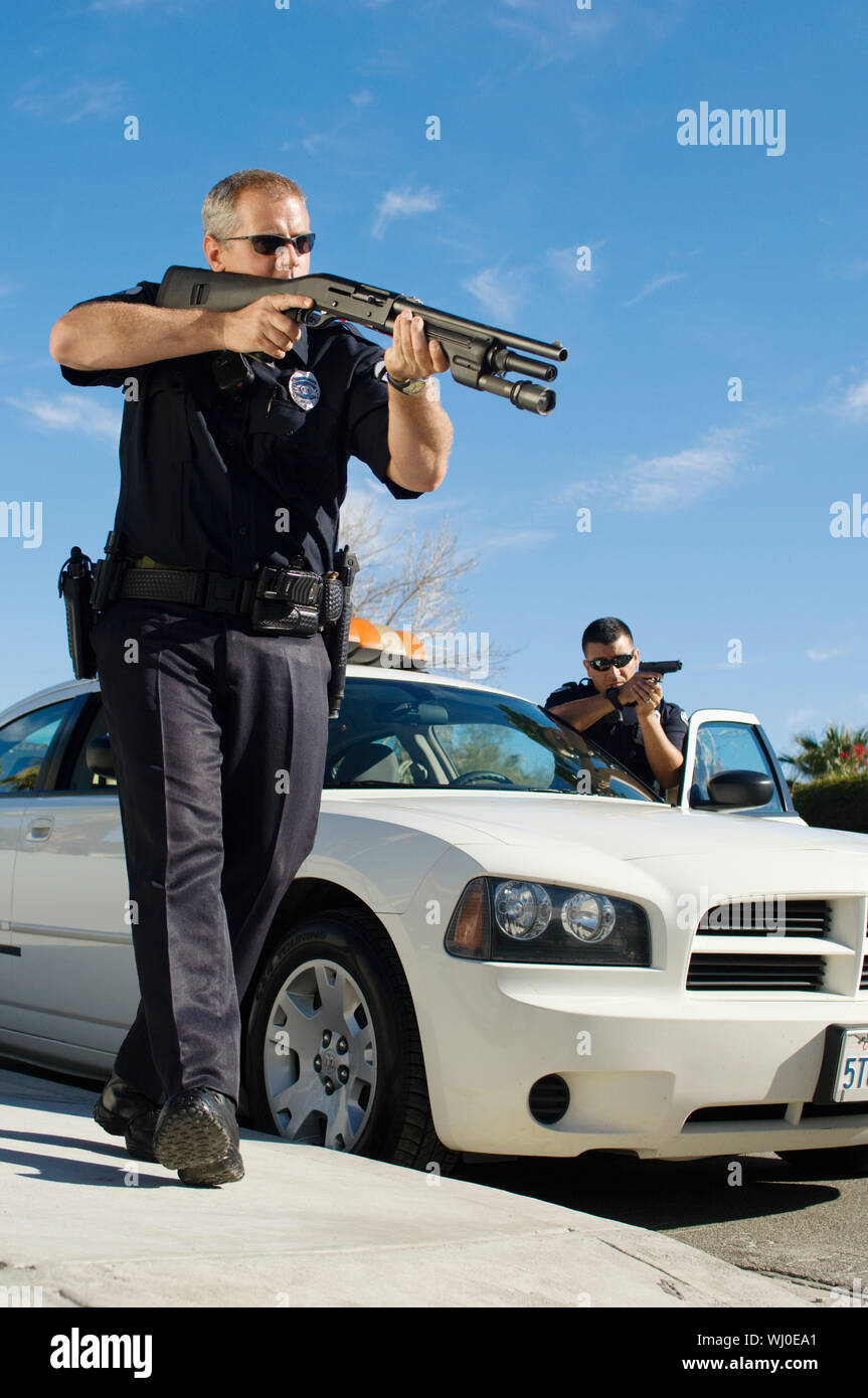 Police Officer Aiming Shotgun Stock Photo - Alamy