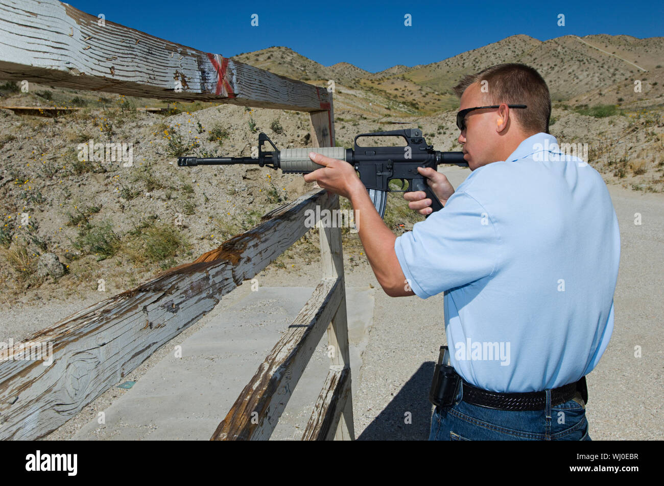 Man aiming rifle at firing range Stock Photo - Alamy