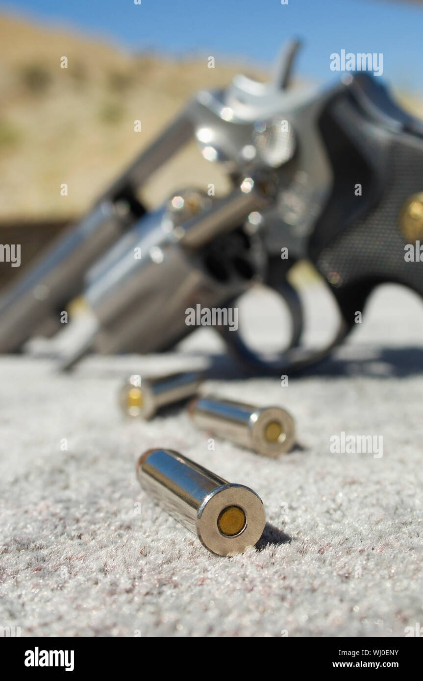 Bullets beside gun, close-up Stock Photo - Alamy
