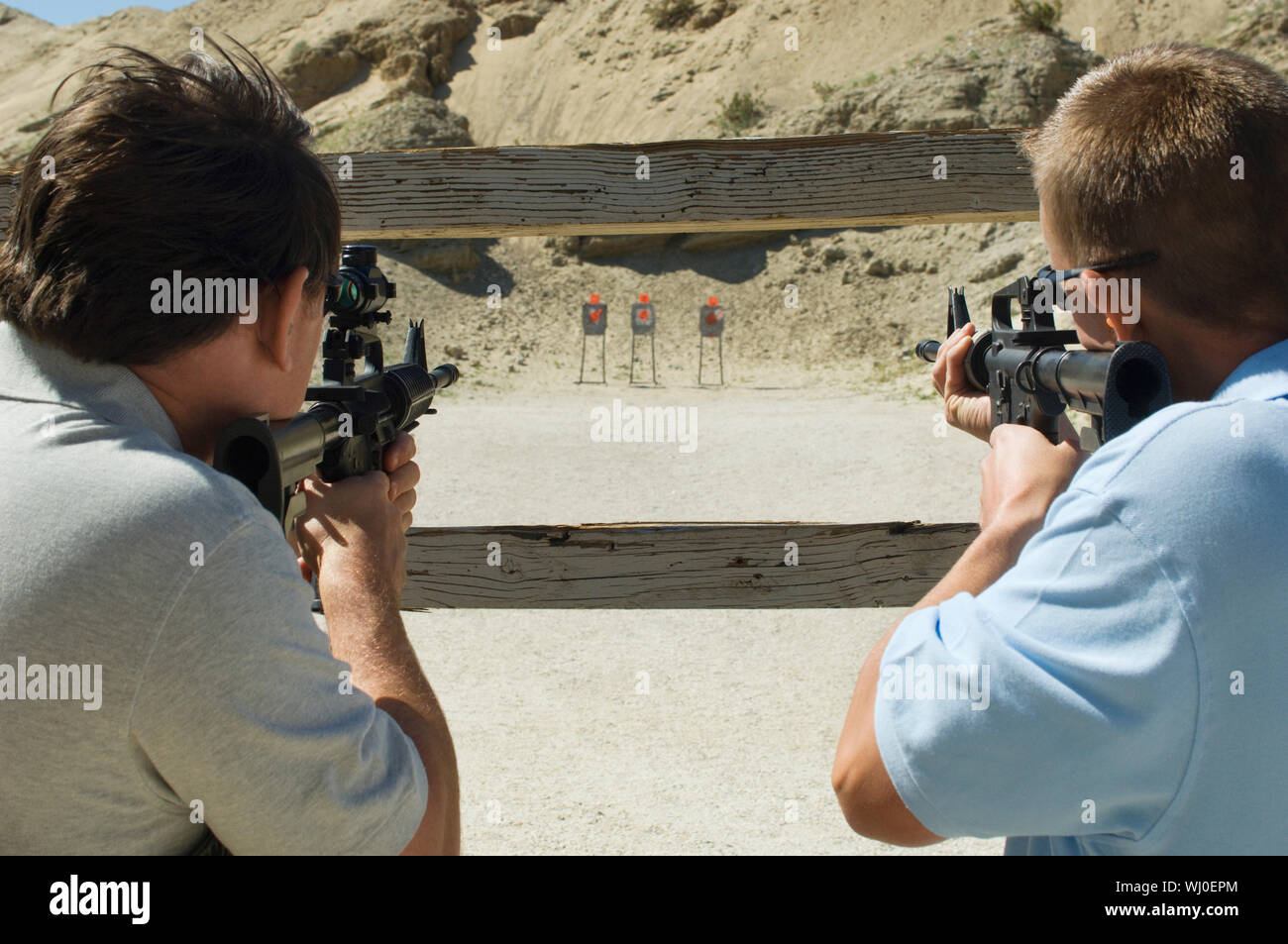 Men aiming rifles at firing range Stock Photo - Alamy