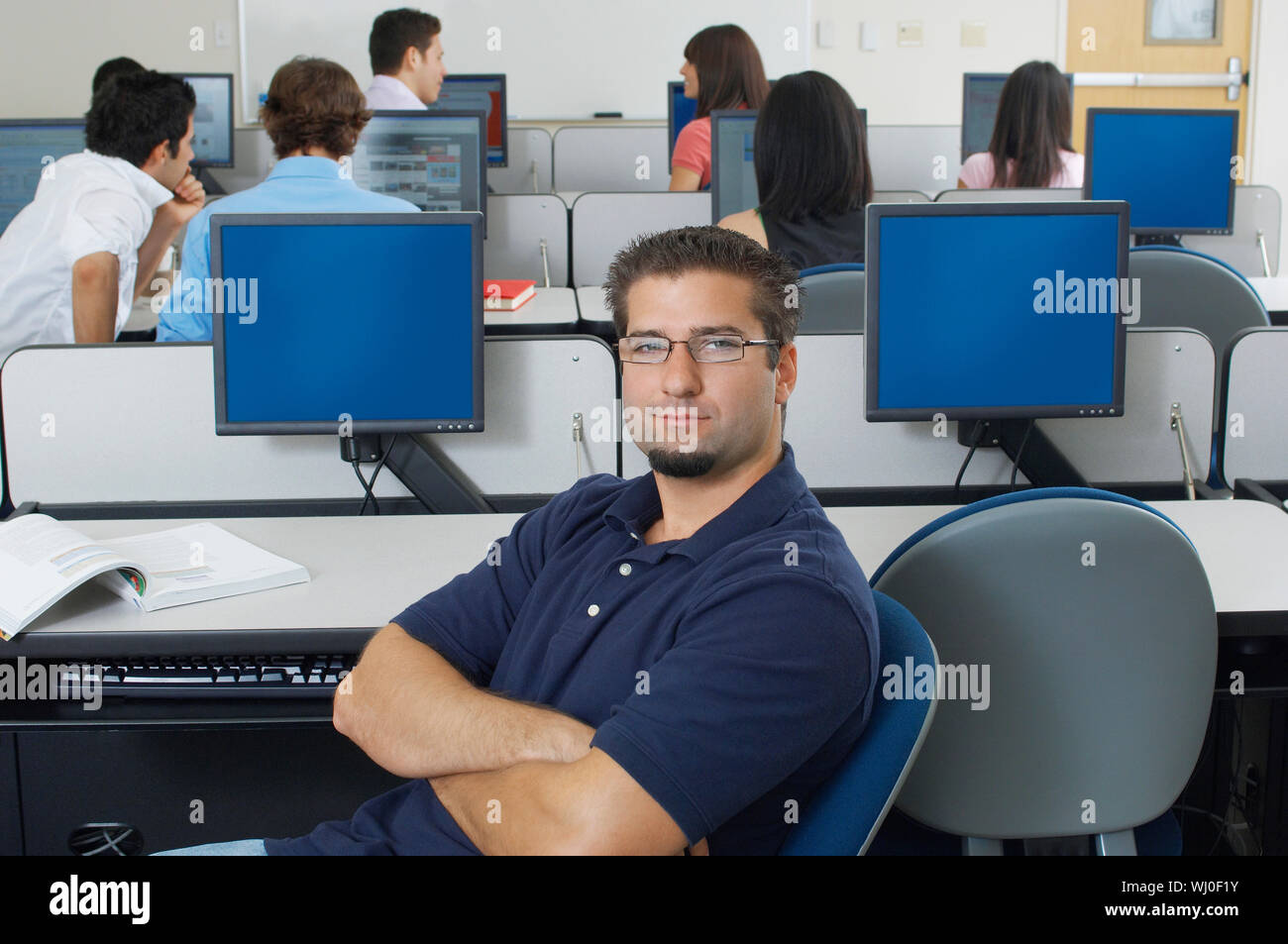 Male student sitting in computer classroom, portrait Stock Photo - Alamy