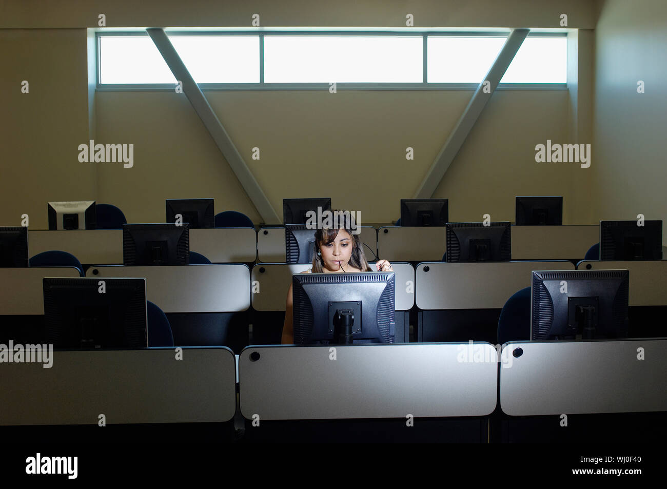 Female student working in computer classroom Stock Photo - Alamy