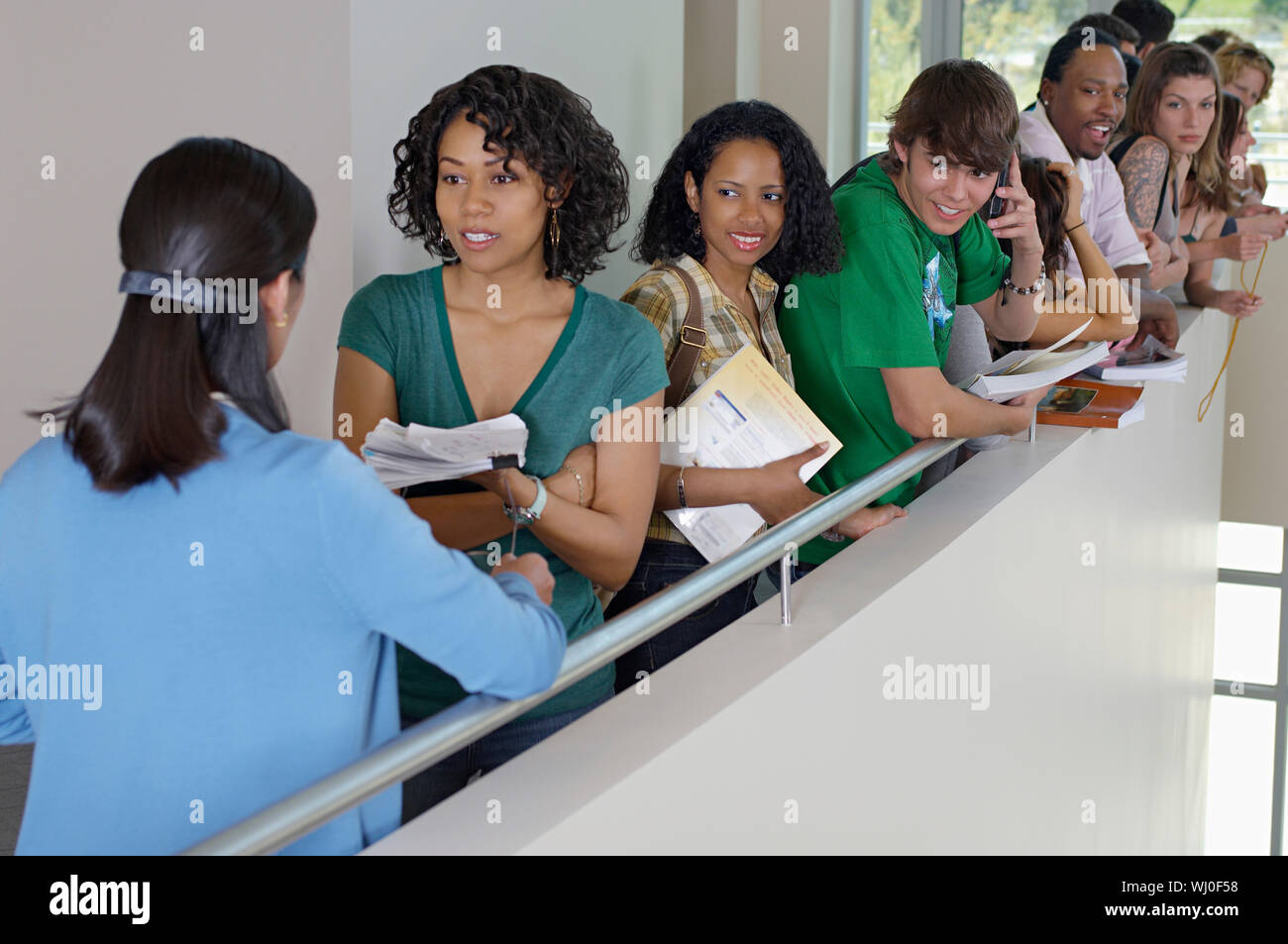 Row of students and teacher standing on balcony in school Stock Photo ...