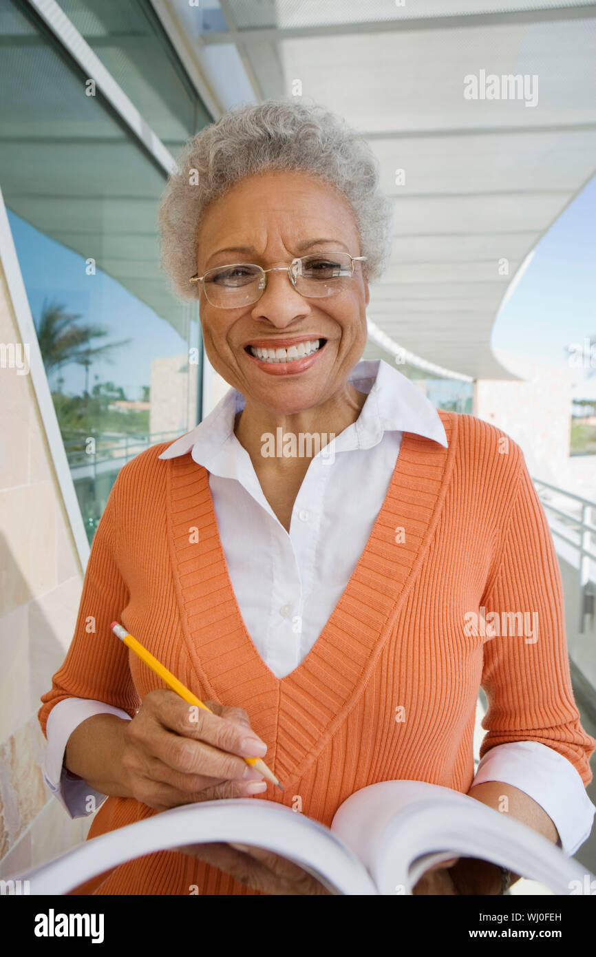 Woman writing in book at school, portrait Stock Photo - Alamy