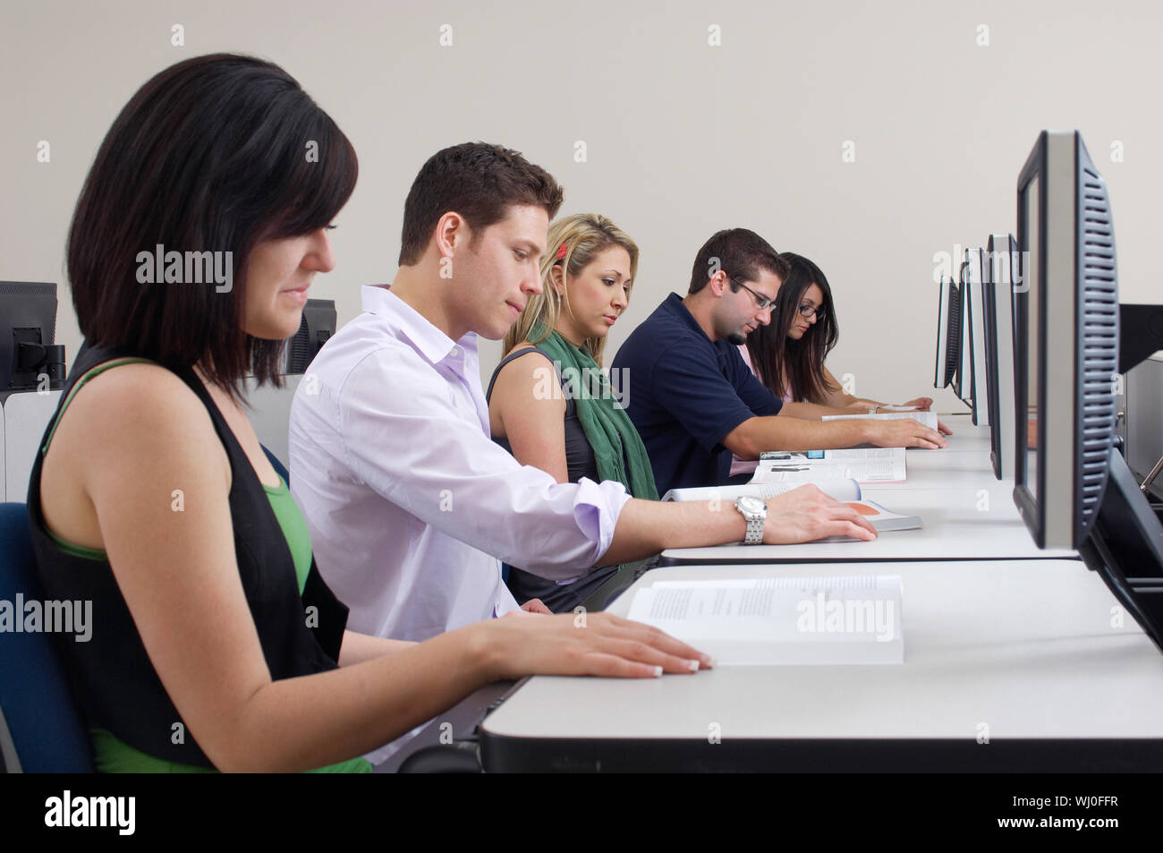 Five students working in computer classroom Stock Photo - Alamy